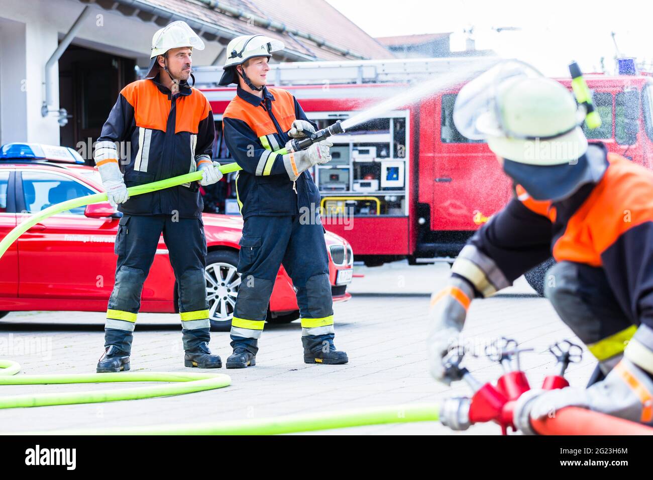 Fire department brigade action water hose hoses hi-res stock ...
