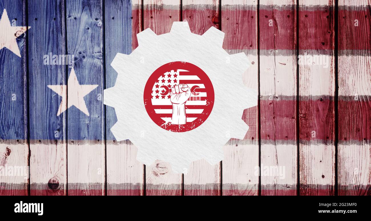 Hand holding a tool over setting icon against american flag on wooden ...