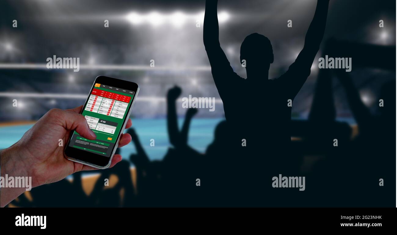 Composition of man using smartphone with sports app over fans at sports ...