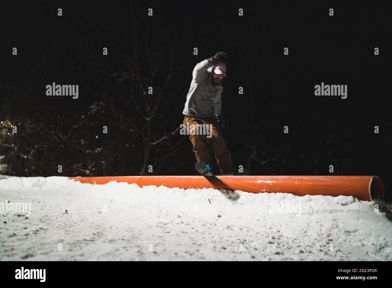 Professional male skier performing stunt while skiing on railing Stock ...