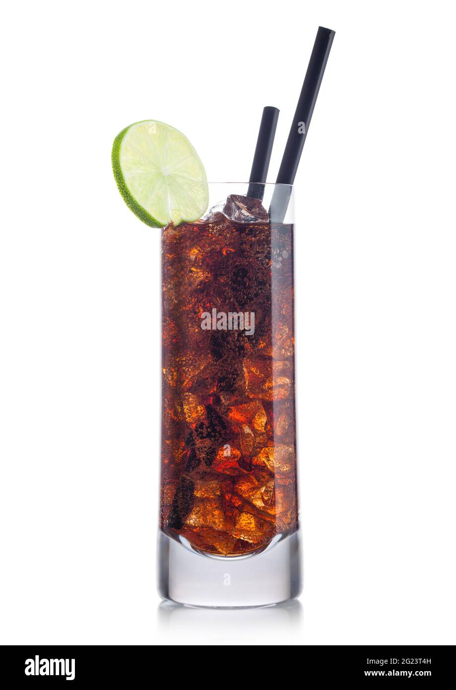 Cuba Libre Cocktail in highball glass with ice cubes and slice of lime with black straw on white ...