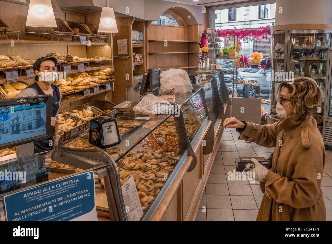 Milan. Bakery in Porta Venezia area serves customers respecting the ...