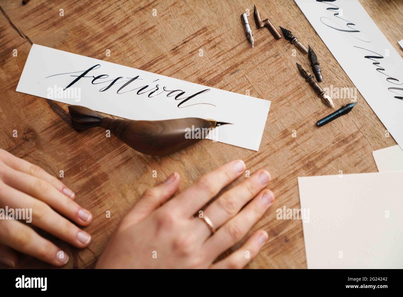 Calligrapher girl writing while working at table indoors Stock Photo ...