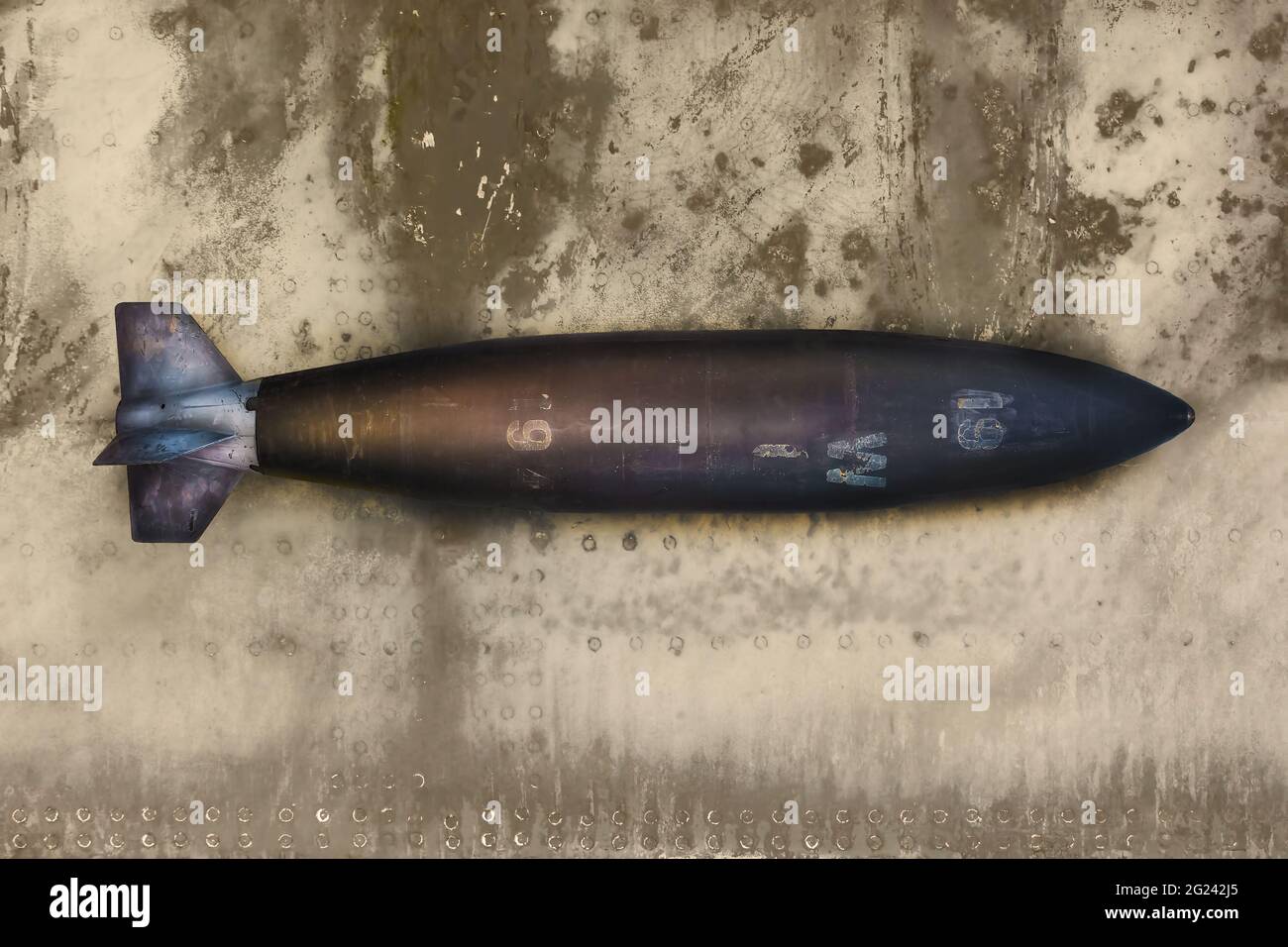 Ancient military missile bomb in front of an eroded steel background ...