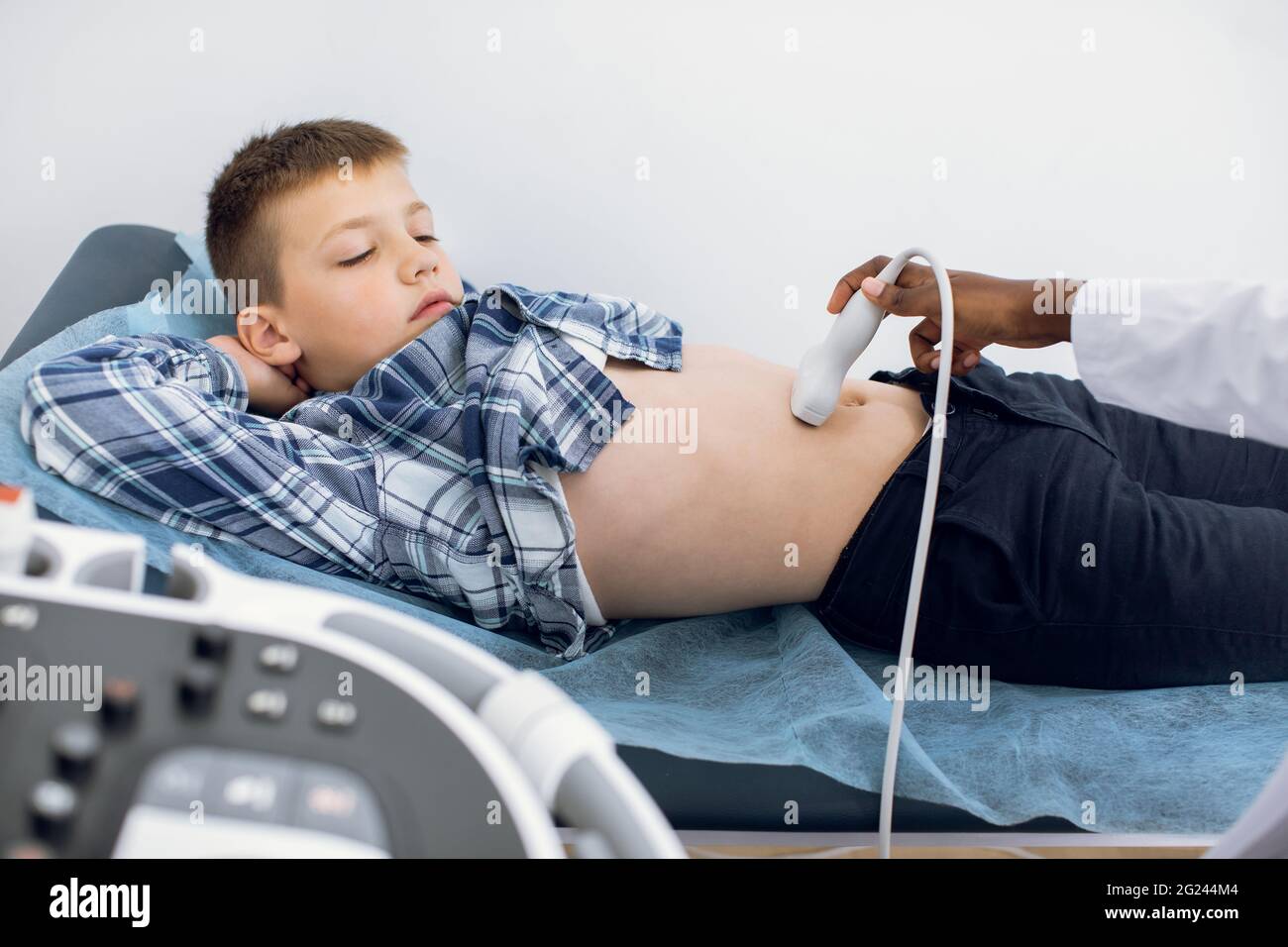 Ultrasound examination of the child in modern clinic. Female doctor ...