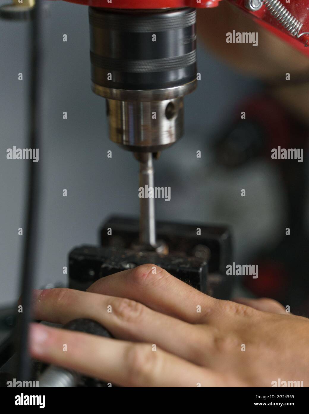 Vertical of the fingers of a woodworker using a woodcutting machine on ...
