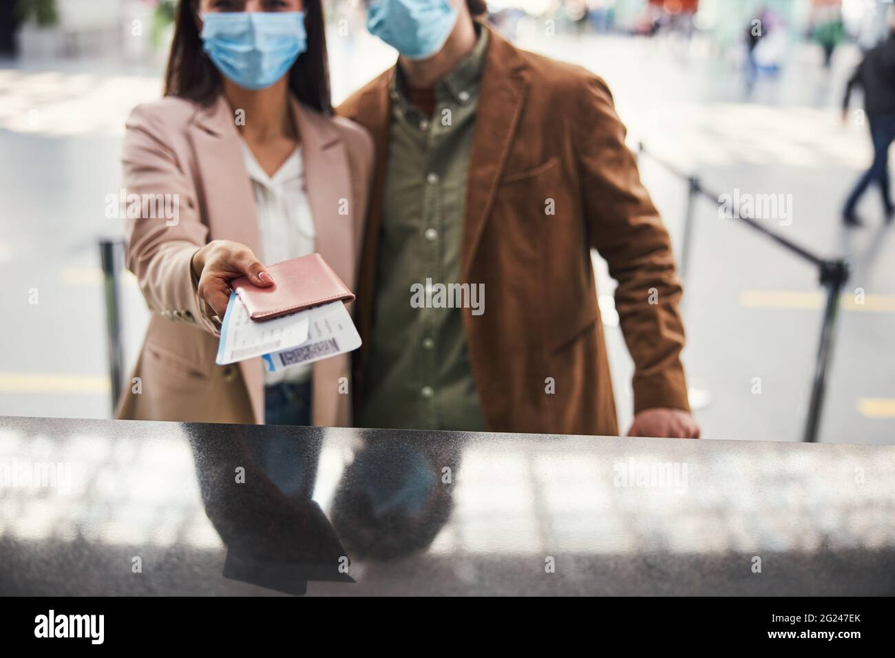 Woman standing airport check in desk hi-res stock photography and ...
