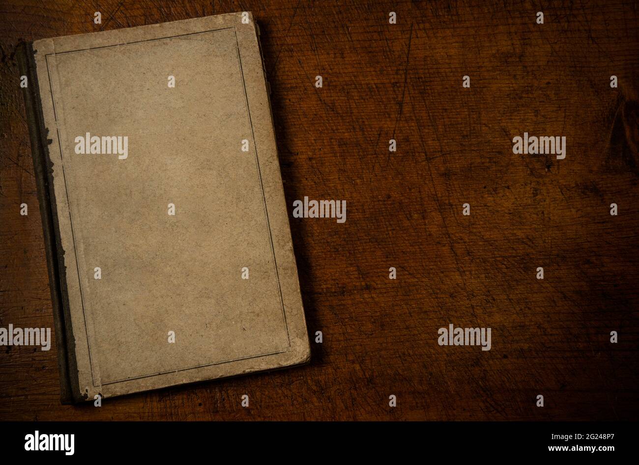 Old book with blank cover resting on old wooden desk top Stock Photo ...