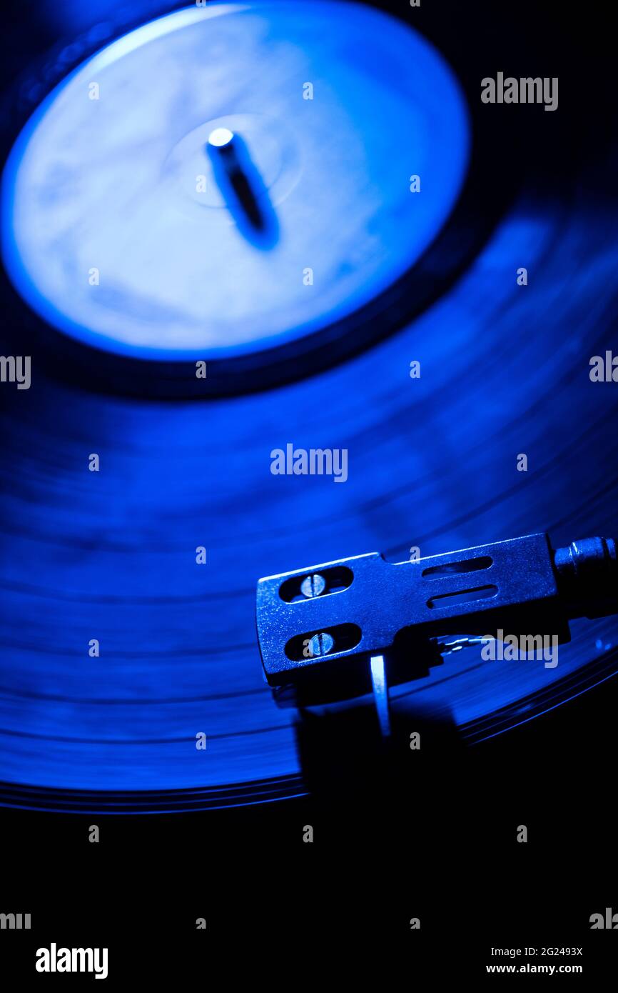 Close-up of a record player needle on record in blue light Stock Photo ...