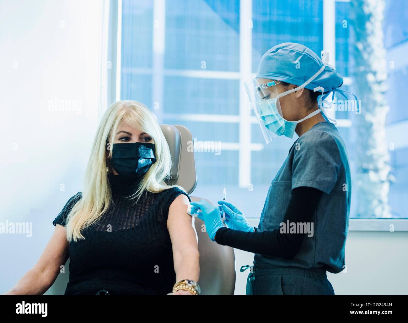 Mature woman receiving vaccine hi-res stock photography and images - Alamy
