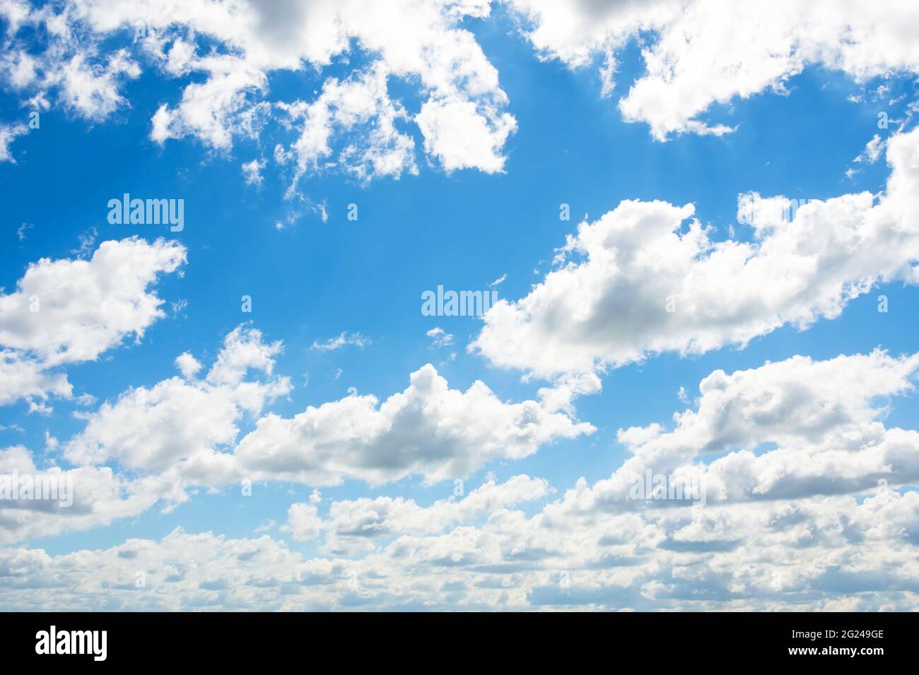 Summer blue sky with white torn scattering fluffy clouds Stock Photo ...