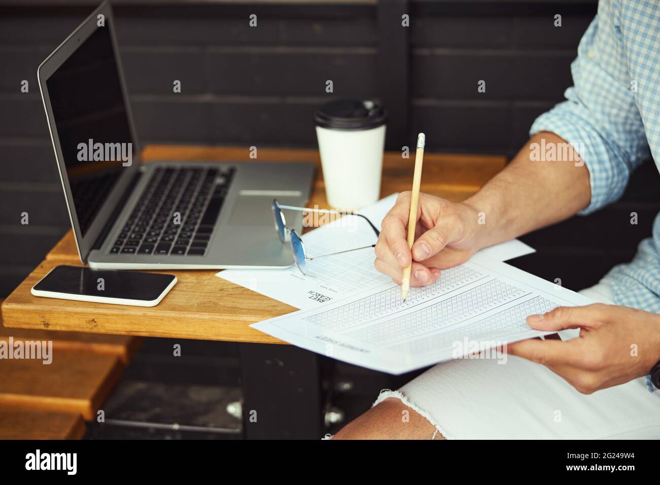 Close up of male hand making notes Stock Photo - Alamy
