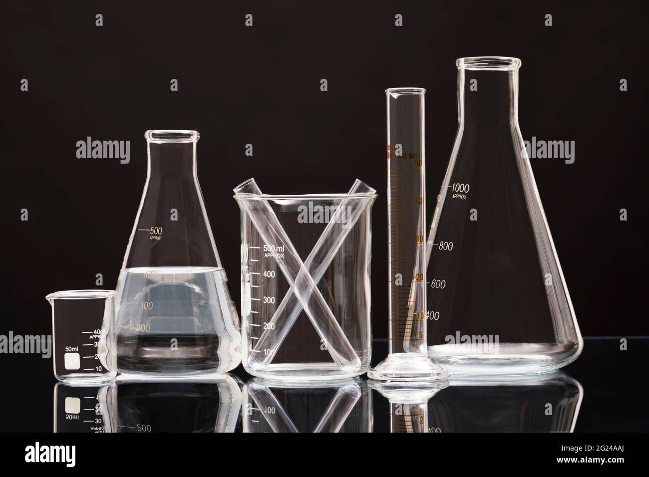 Laboratory glassware against black background Stock Photo - Alamy