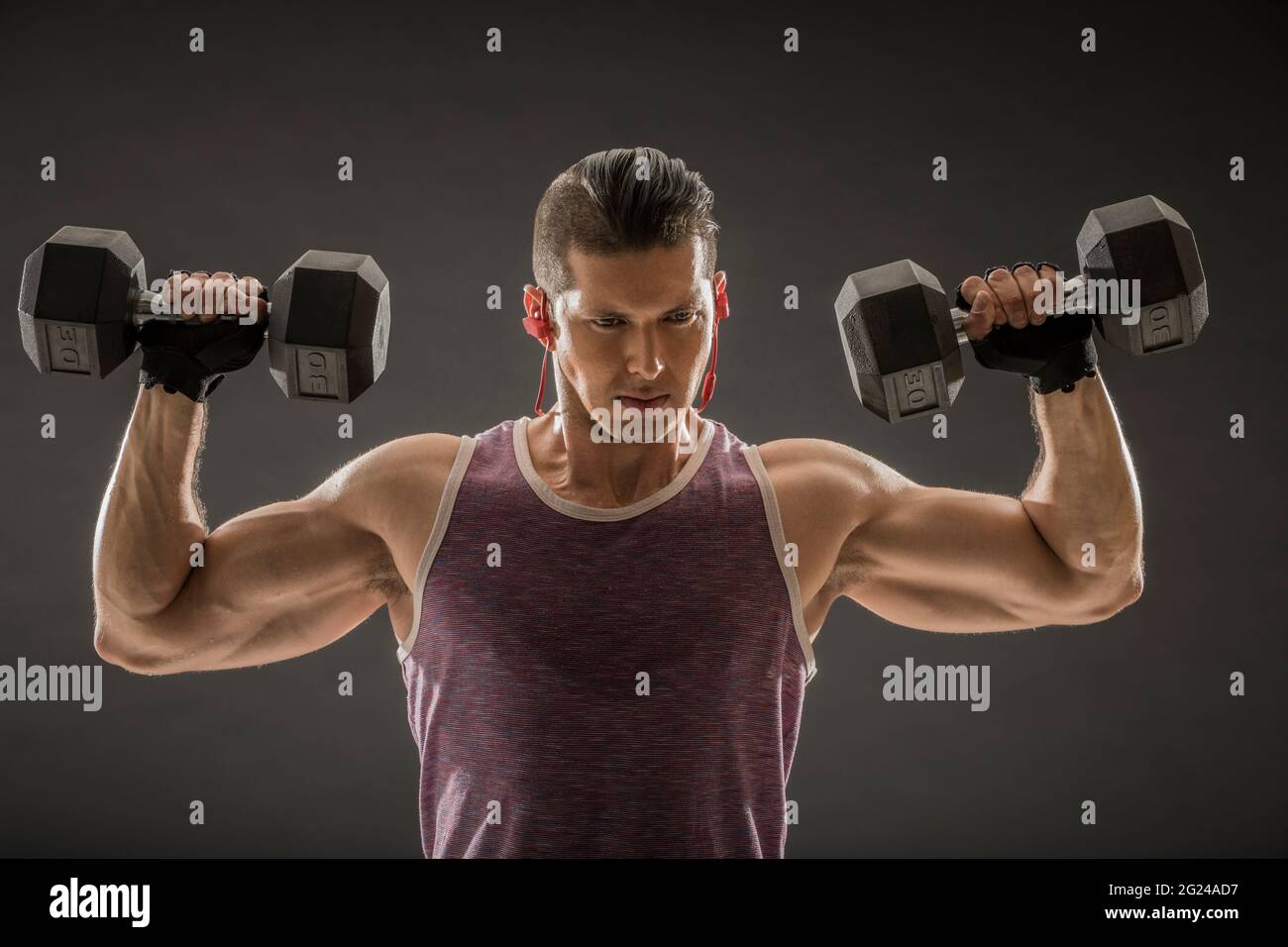 Muscular man training with dumbbells Stock Photo - Alamy
