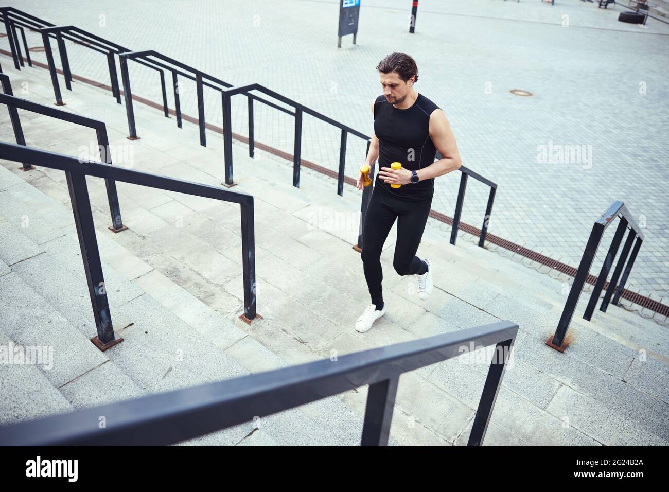 Young man running upstairs hi-res stock photography and images - Alamy