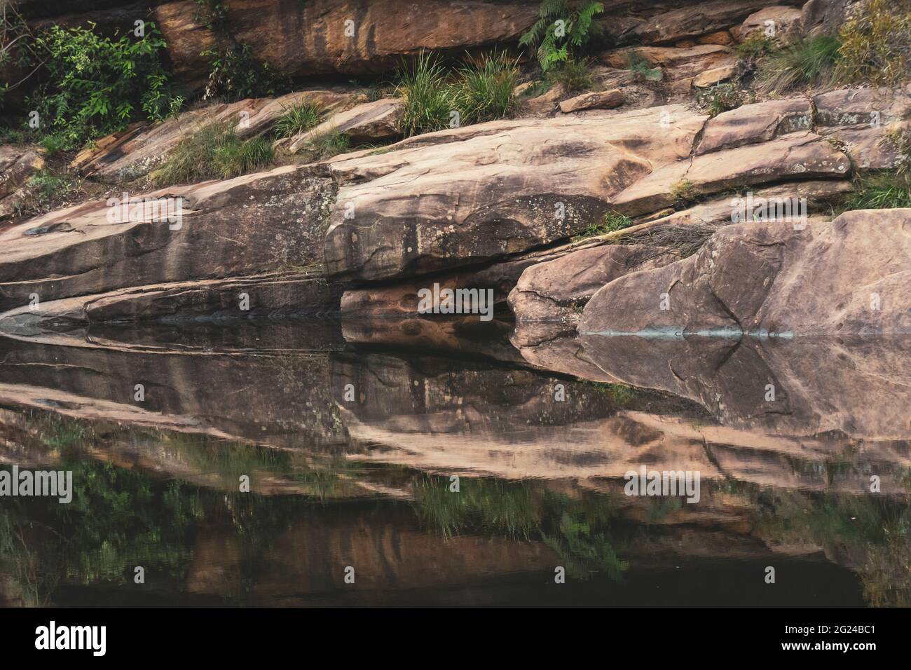 Australia, New South Wales, Sandstone rocks reflecting in Jellybean ...