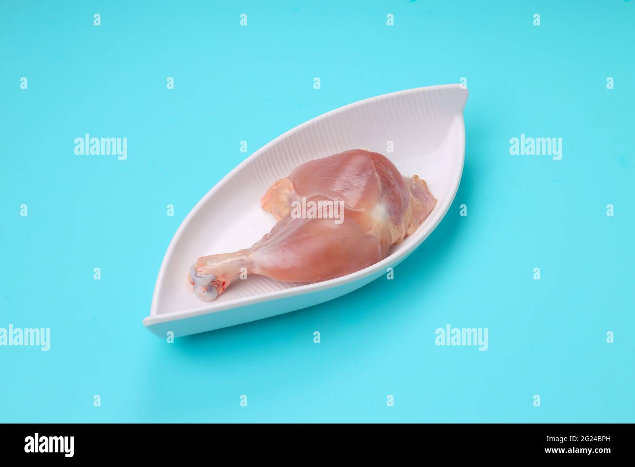Raw whole chicken leg without skin arranged in a beautiful oval shape ...