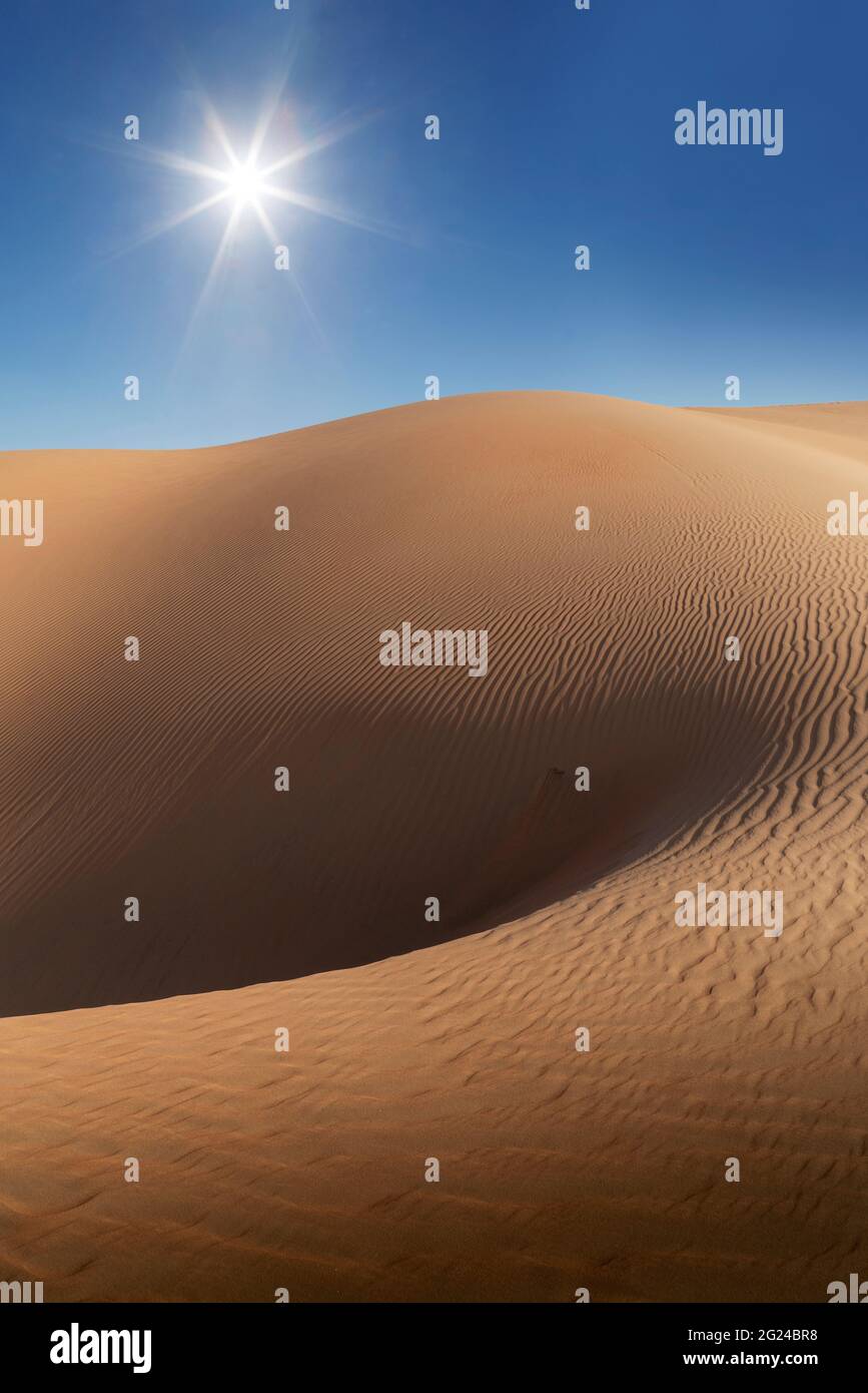 Dubai, United Arab Emirates, Sun shining over sand dunes in desert ...