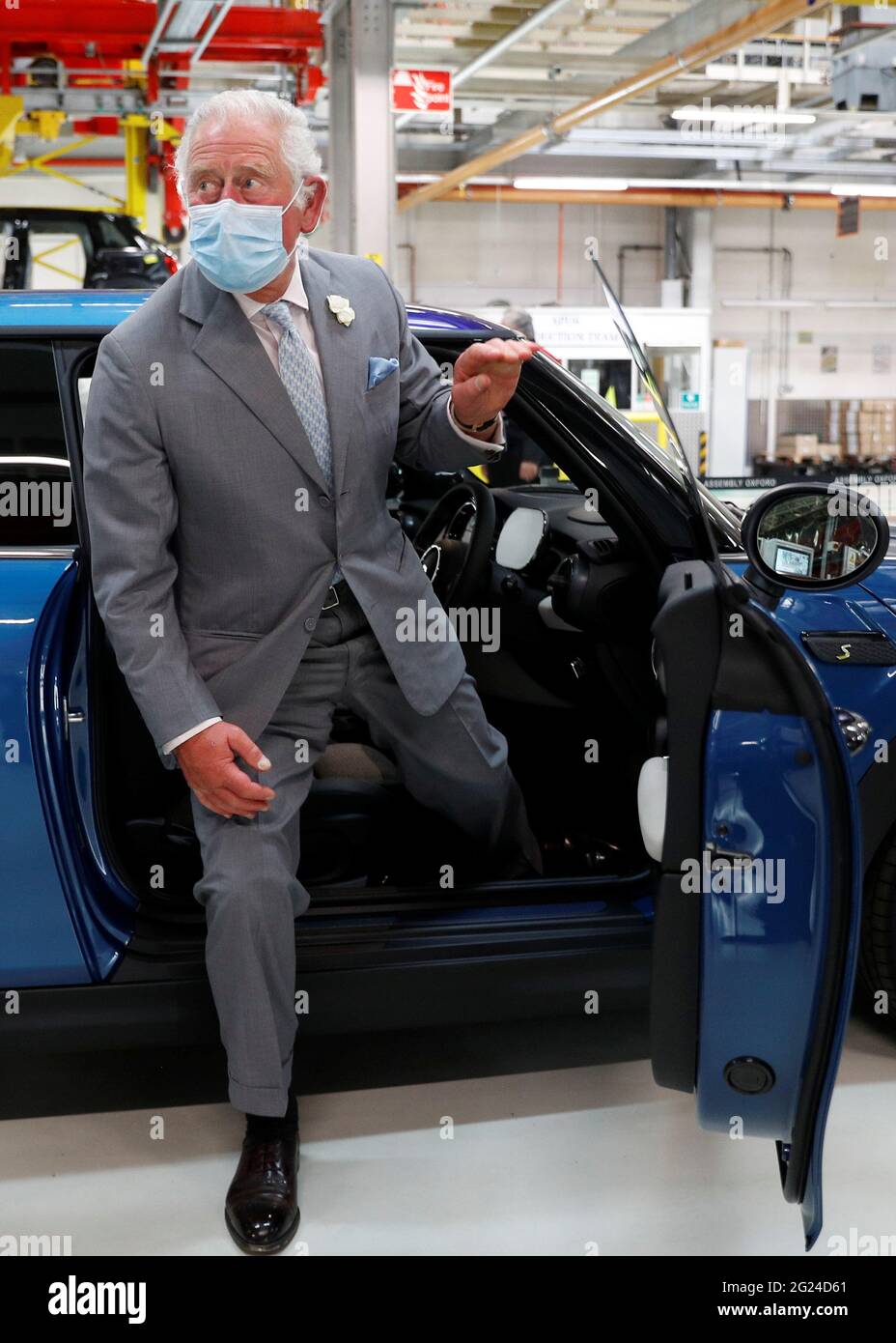 The Prince of Wales gets out of a MINI car during a visit to the MINI ...