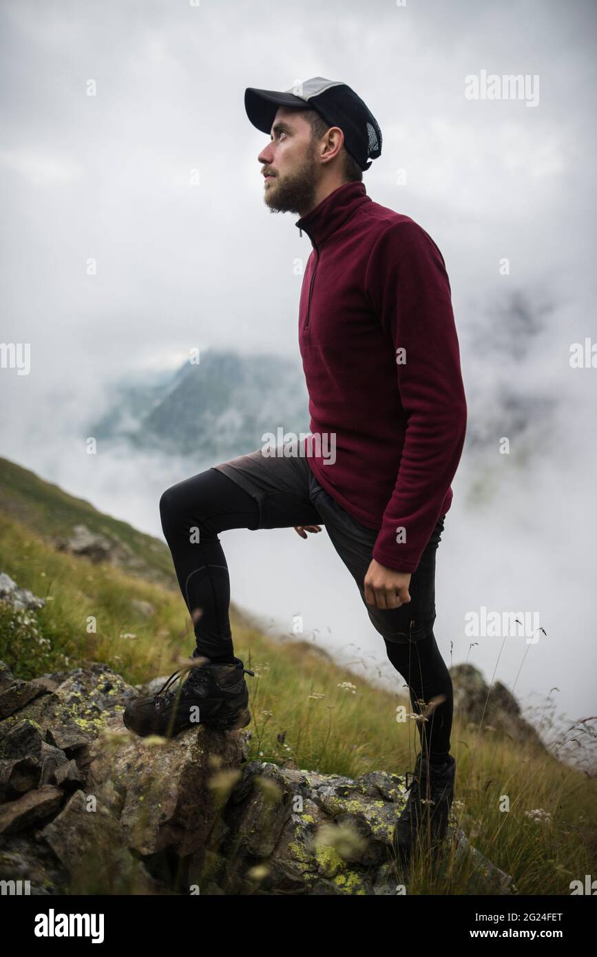 Switzerland, Appenzell, Young man hiking in Swiss Alps Stock Photo - Alamy