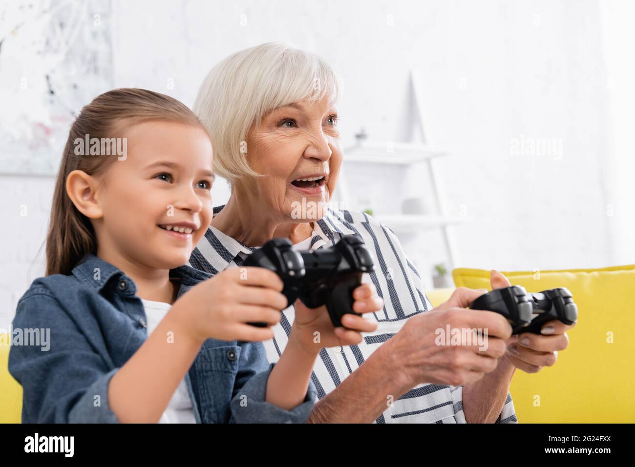 Grandmother granddaughter playing video game hi-res stock photography ...