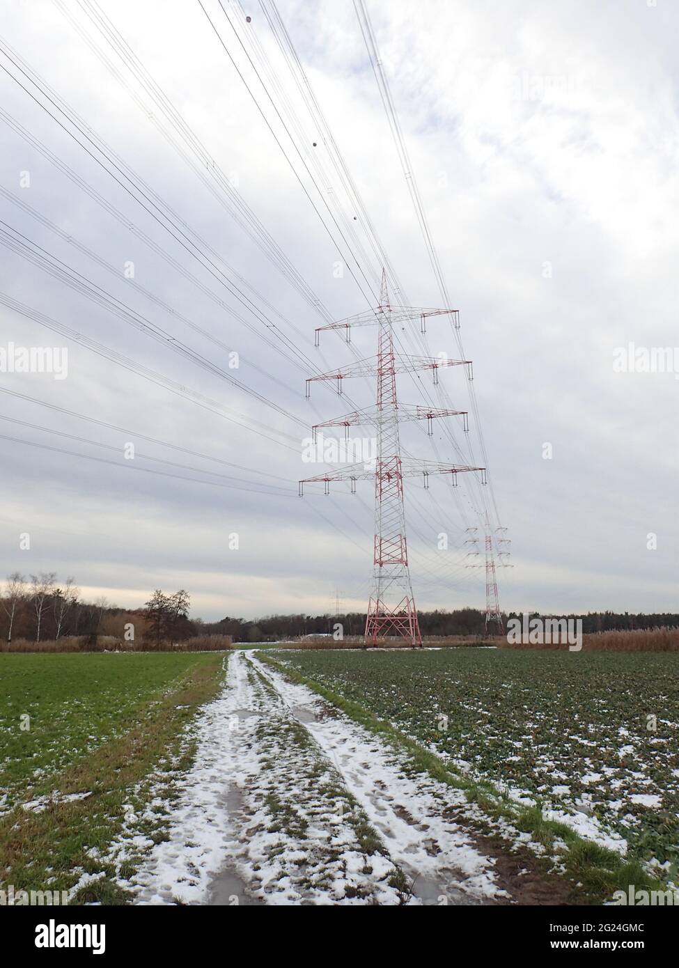 Eerie landscape of electrical network infrastructure on the snowy field ...