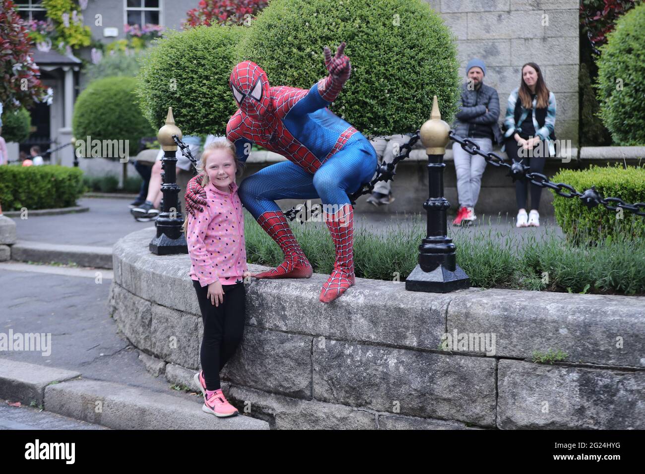 A person in costume, dressed as Spiderman, in Enniskerry village in ...