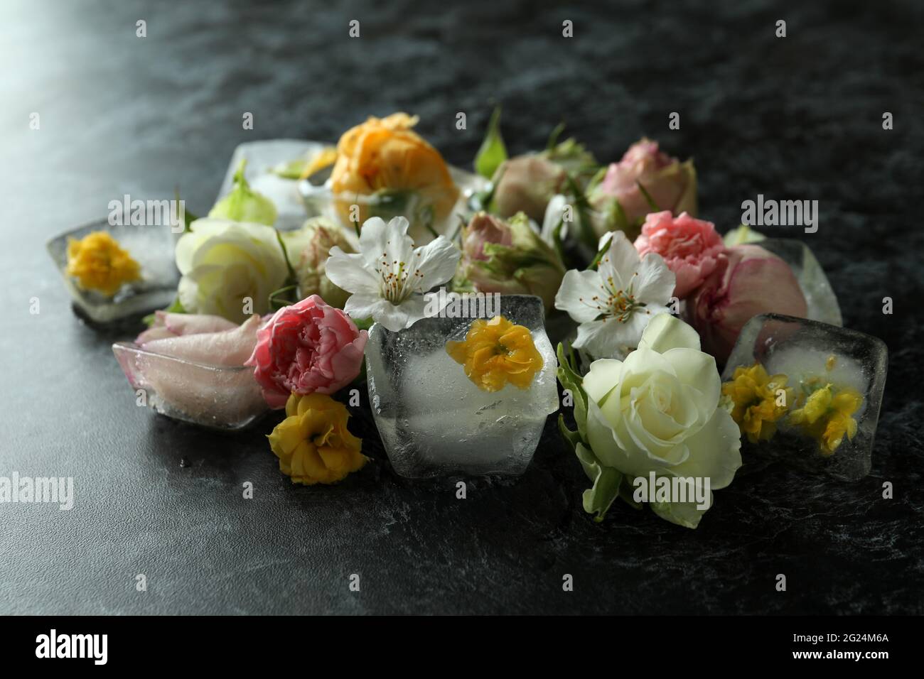 Flowers and ice cubes on black smokey background Stock Photo - Alamy