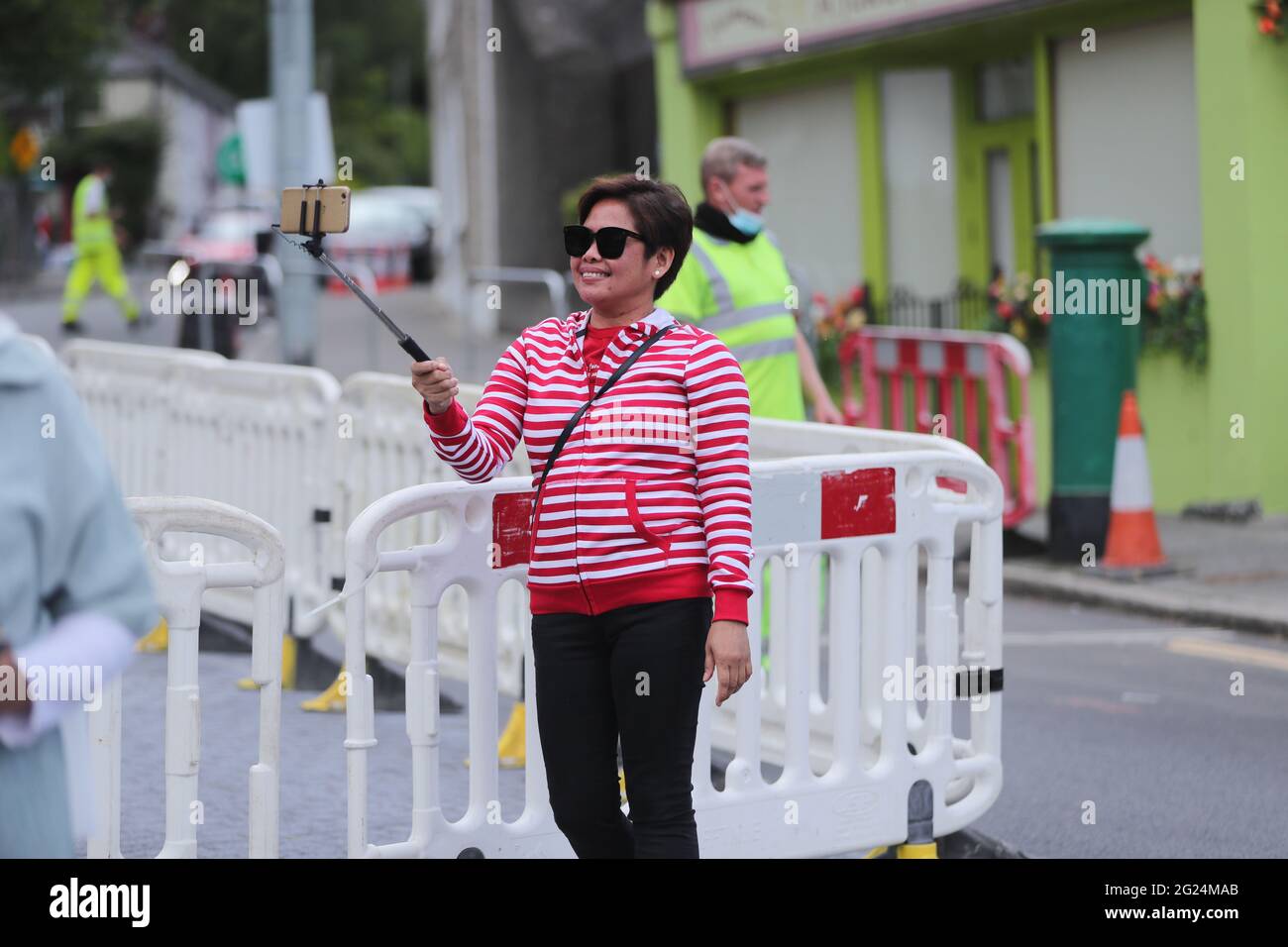 People take photographs whilst workers transform Enniskerry village in ...