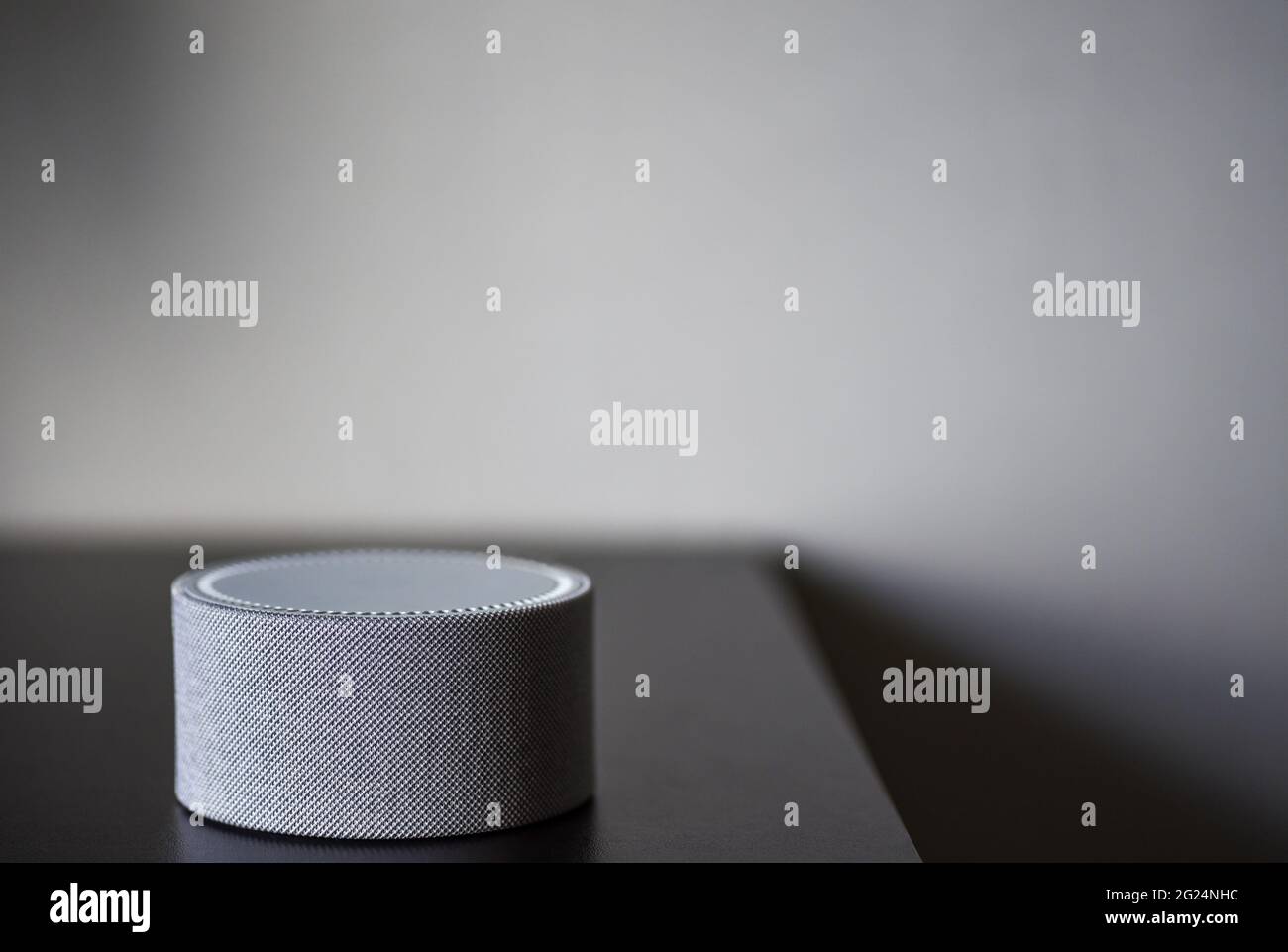Smart speaker with voice assistant on the table Stock Photo - Alamy