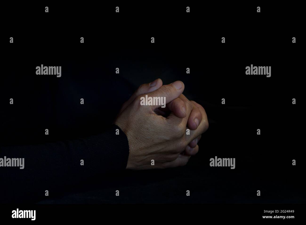 praying hands on black background. faith and praise concept Stock Photo ...