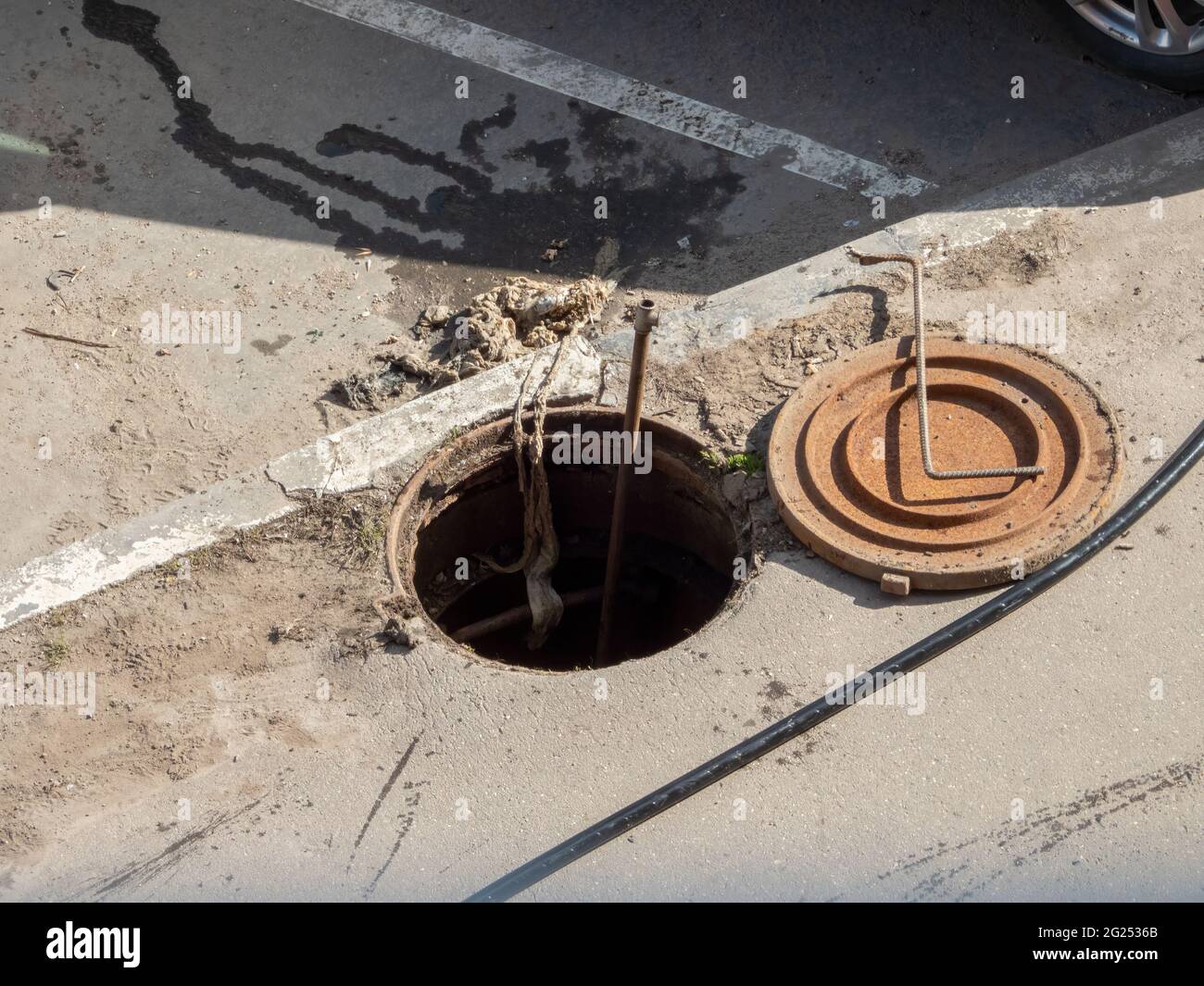 Open sewer hatch Stock Photo - Alamy