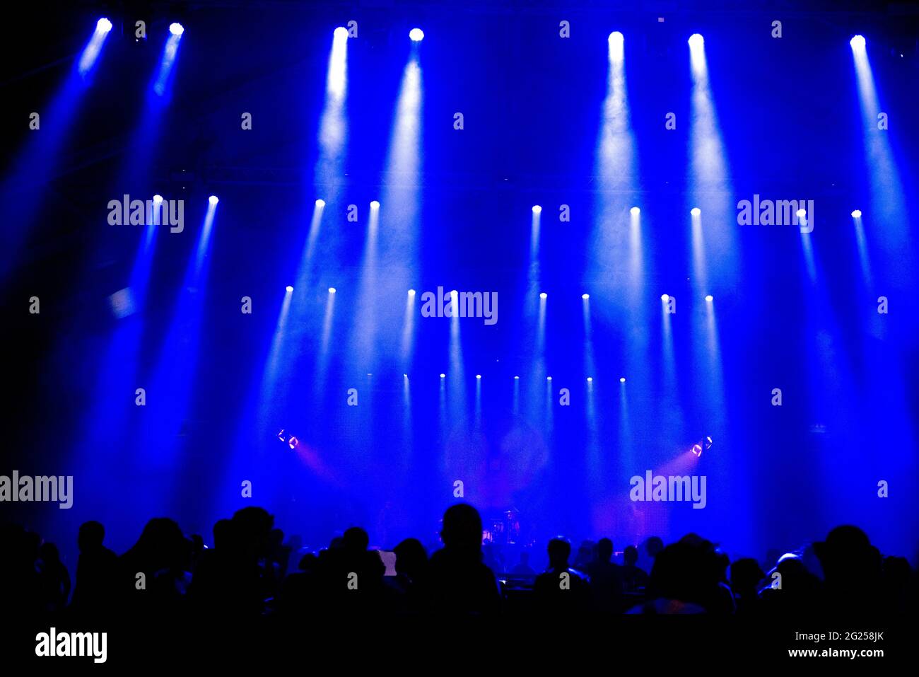 Crowd of people enjoying music festival. Live concert and blue stage lights Stock Photo - Alamy
