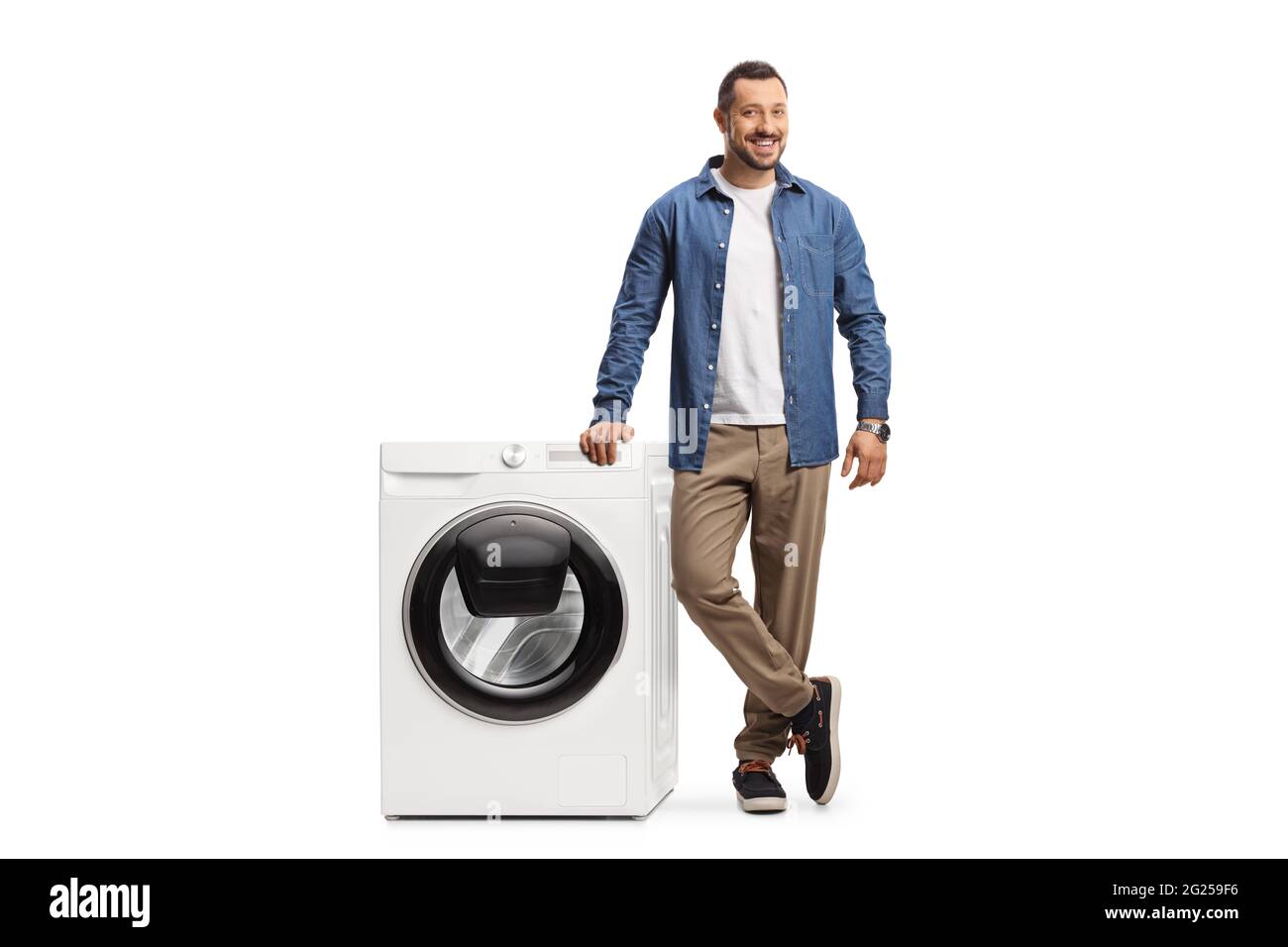 Casual young man leaning on a washing machine isolated on white ...