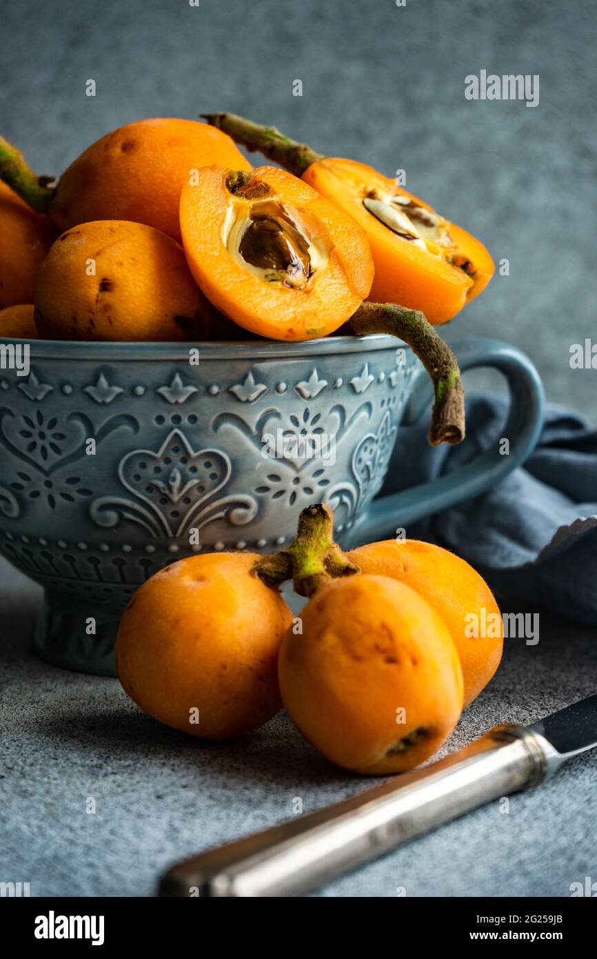 Eating loquat fruit hi-res stock photography and images - Alamy
