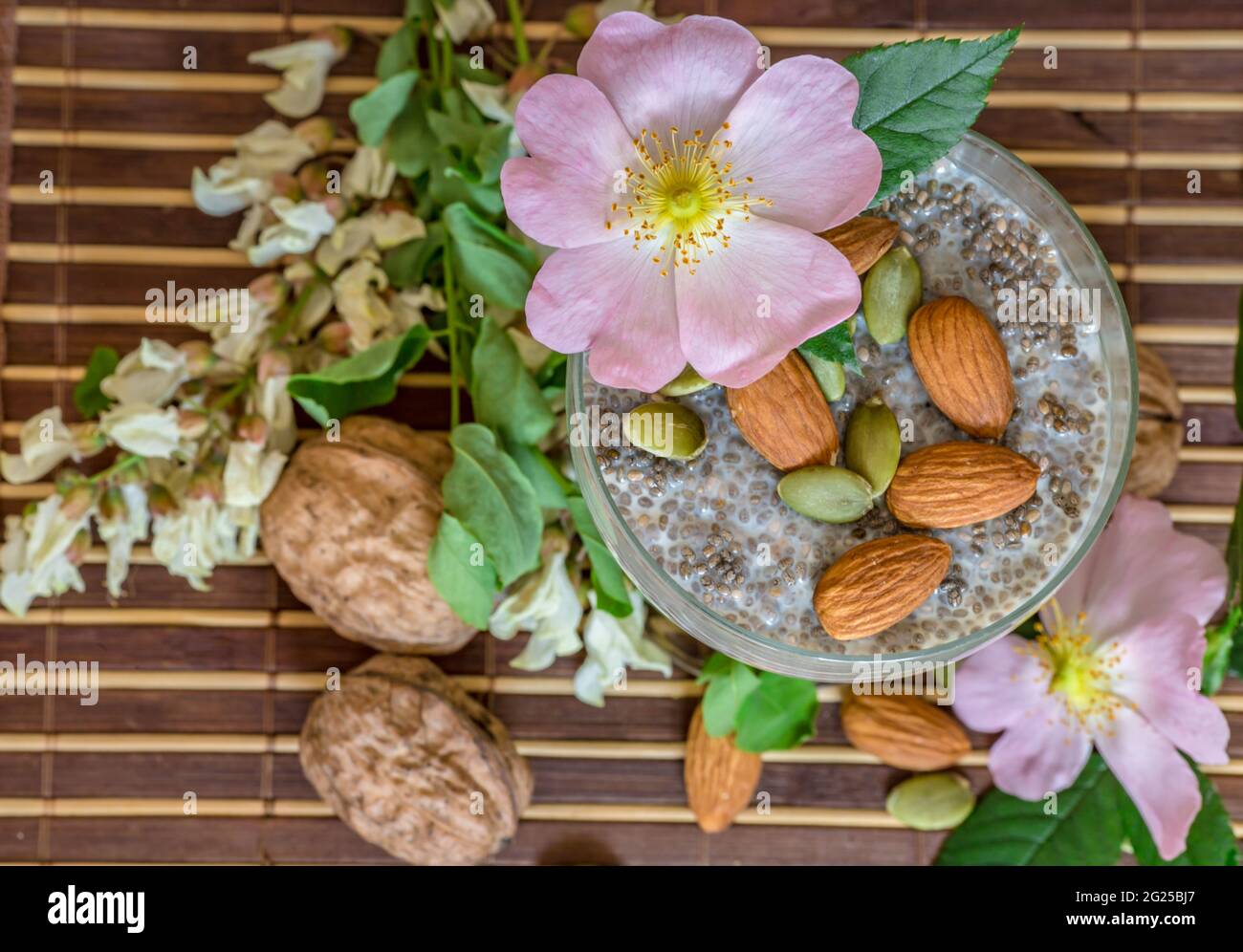 Top view of chia seed pudding with dog-rose flowers, almond milk, and ...