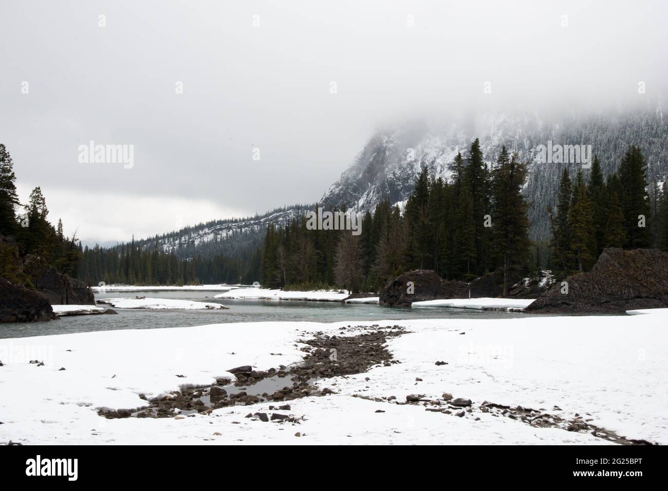 Winter landscape with snowed mountains and river at Banff National Park ...