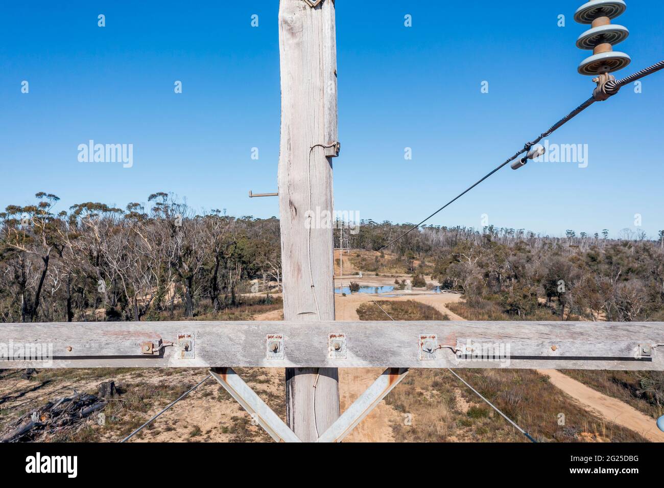Drone aerial photograph of a telephone pole and wires in a forest ...