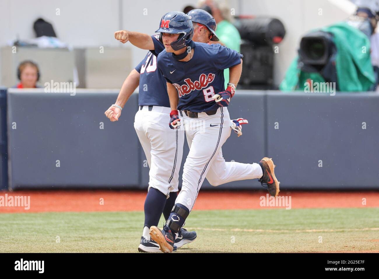 June 07, 2021: Ole Miss infielder Justin Bench (8) fist bumps with ...