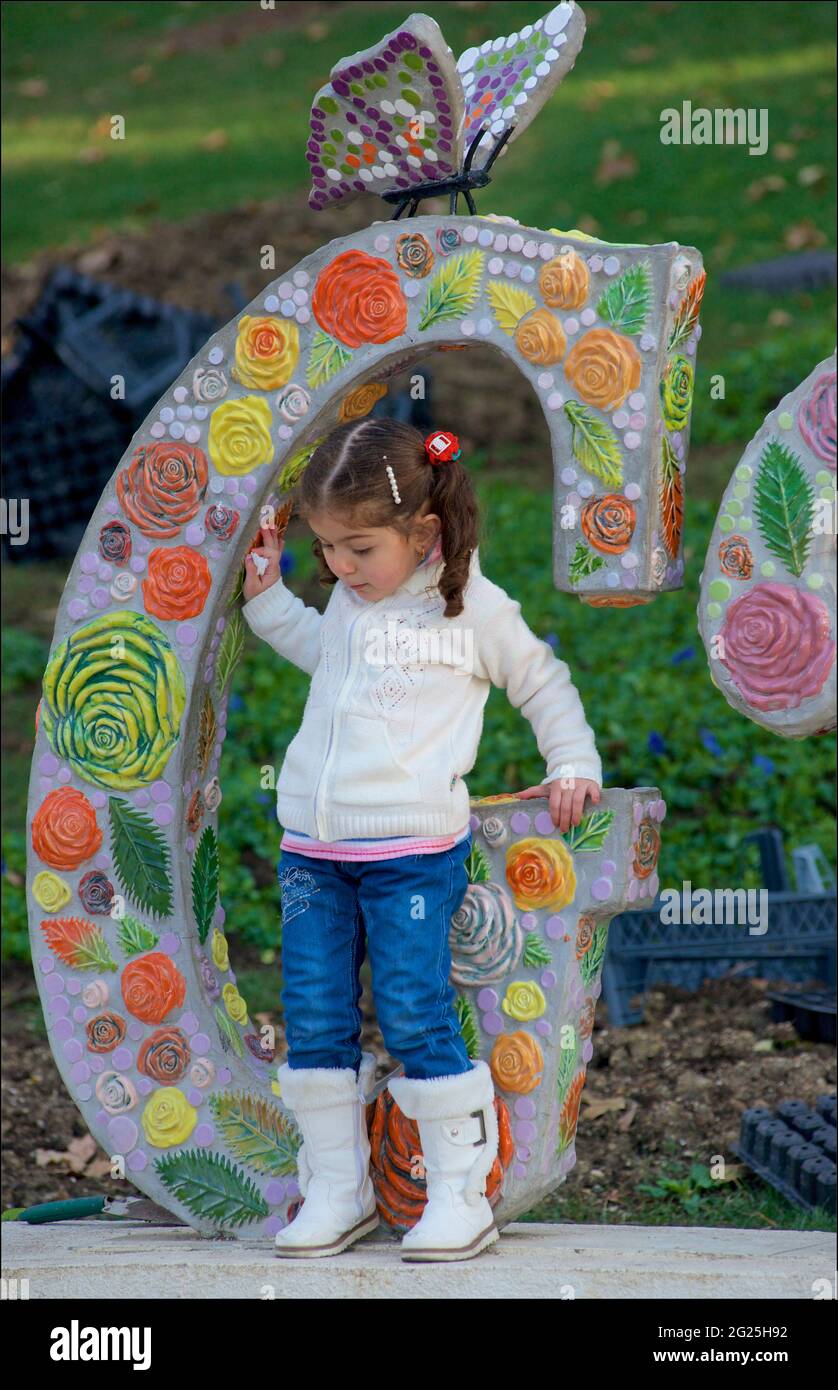 Young Turkish girl standing in a sculpture of a letter 'G' in GŸlhane ...
