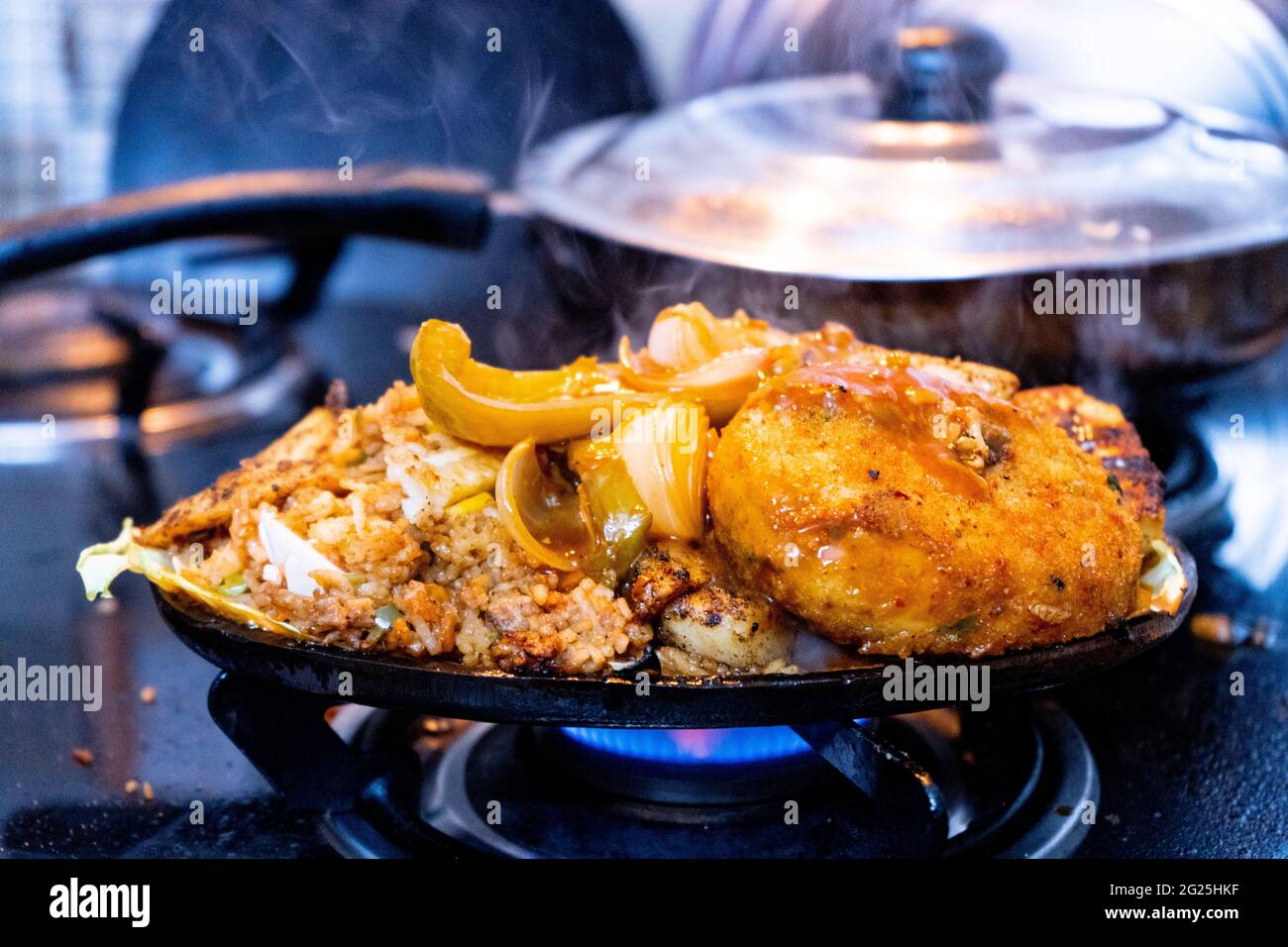 indian mixed vegatable dish sizzler with rice, fries, potato ...