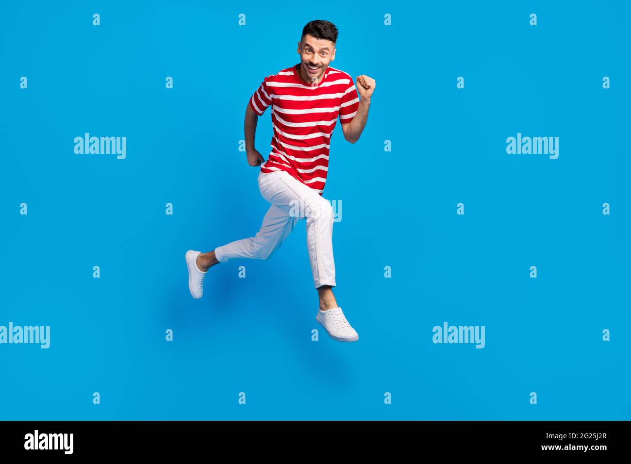 Full body profile side photo of handsome excited happy man jump up run ...