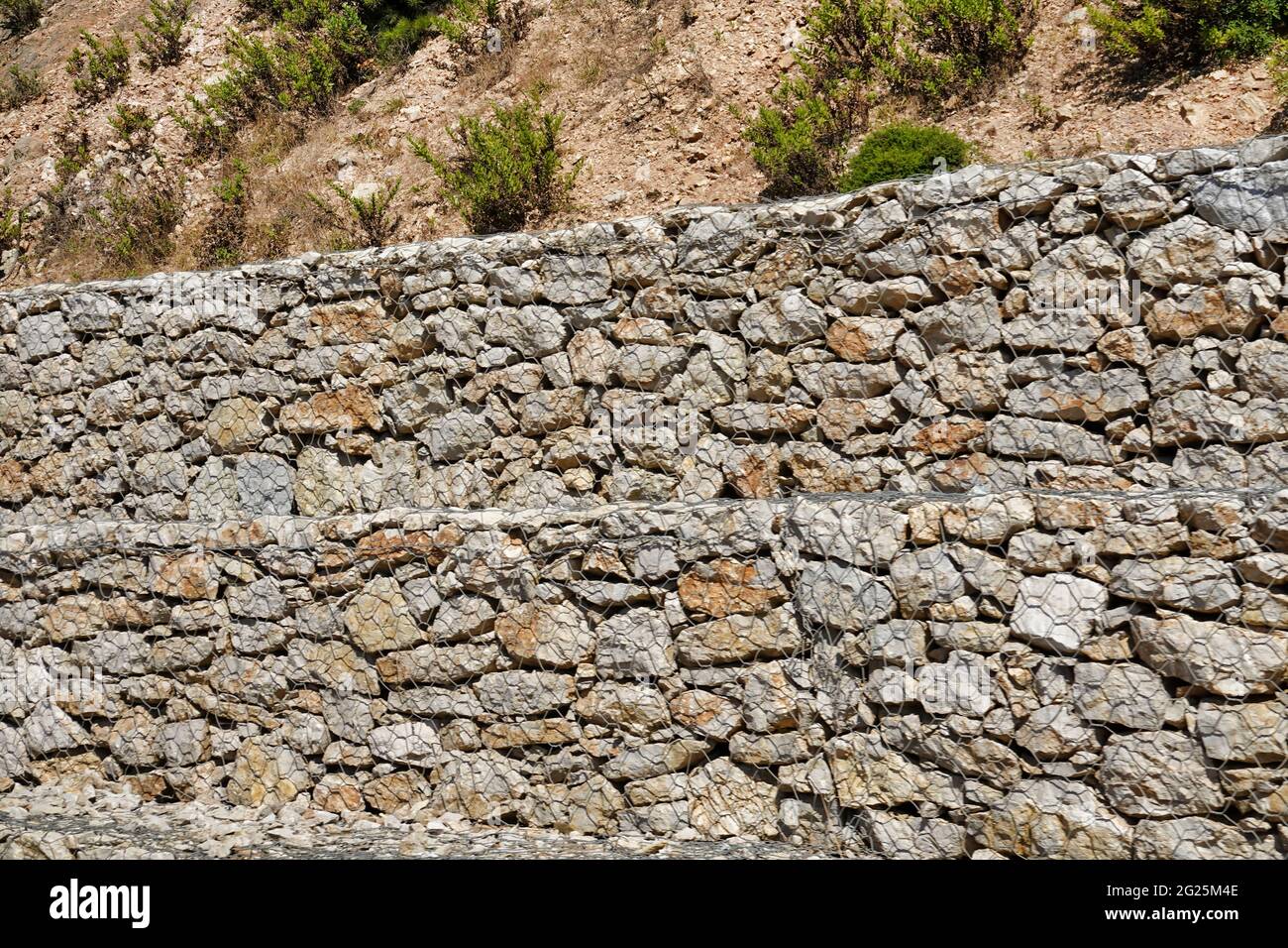 Natural view of piled rock-wall on the foot of a hill in the ...