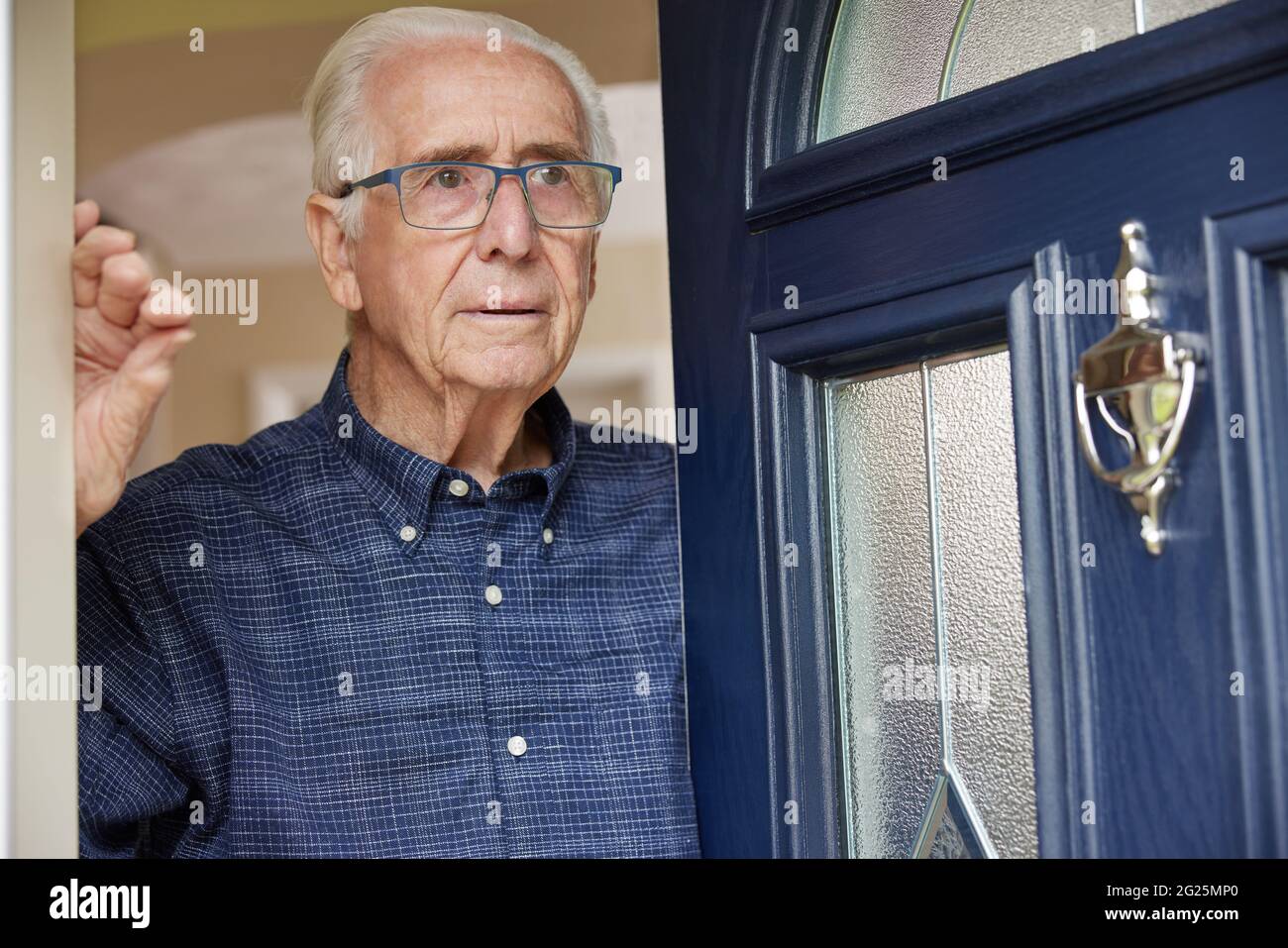 Suspicious man at door hi-res stock photography and images - Alamy