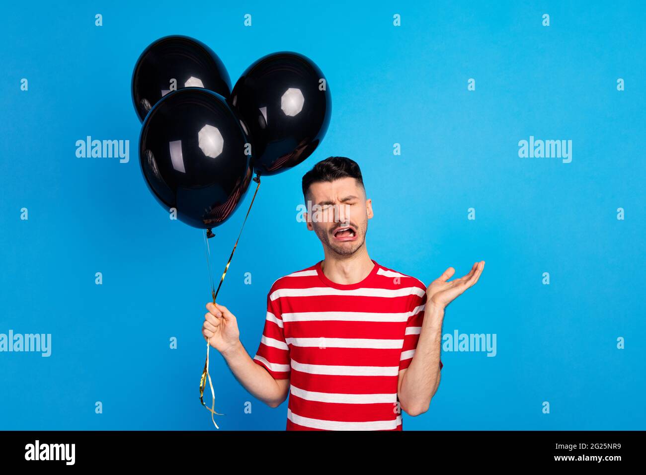 Photo of unhappy miserable young man cry hold balloons upset on ...