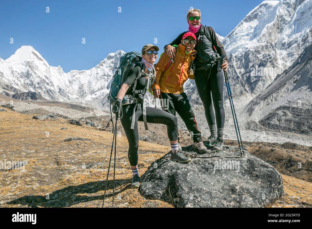 2 women climbers pose with their climbing sherpa & friend near Everest ...