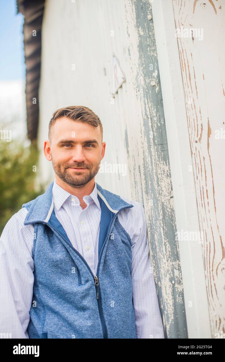 Young Man looking at camera with a smirk Stock Photo - Alamy
