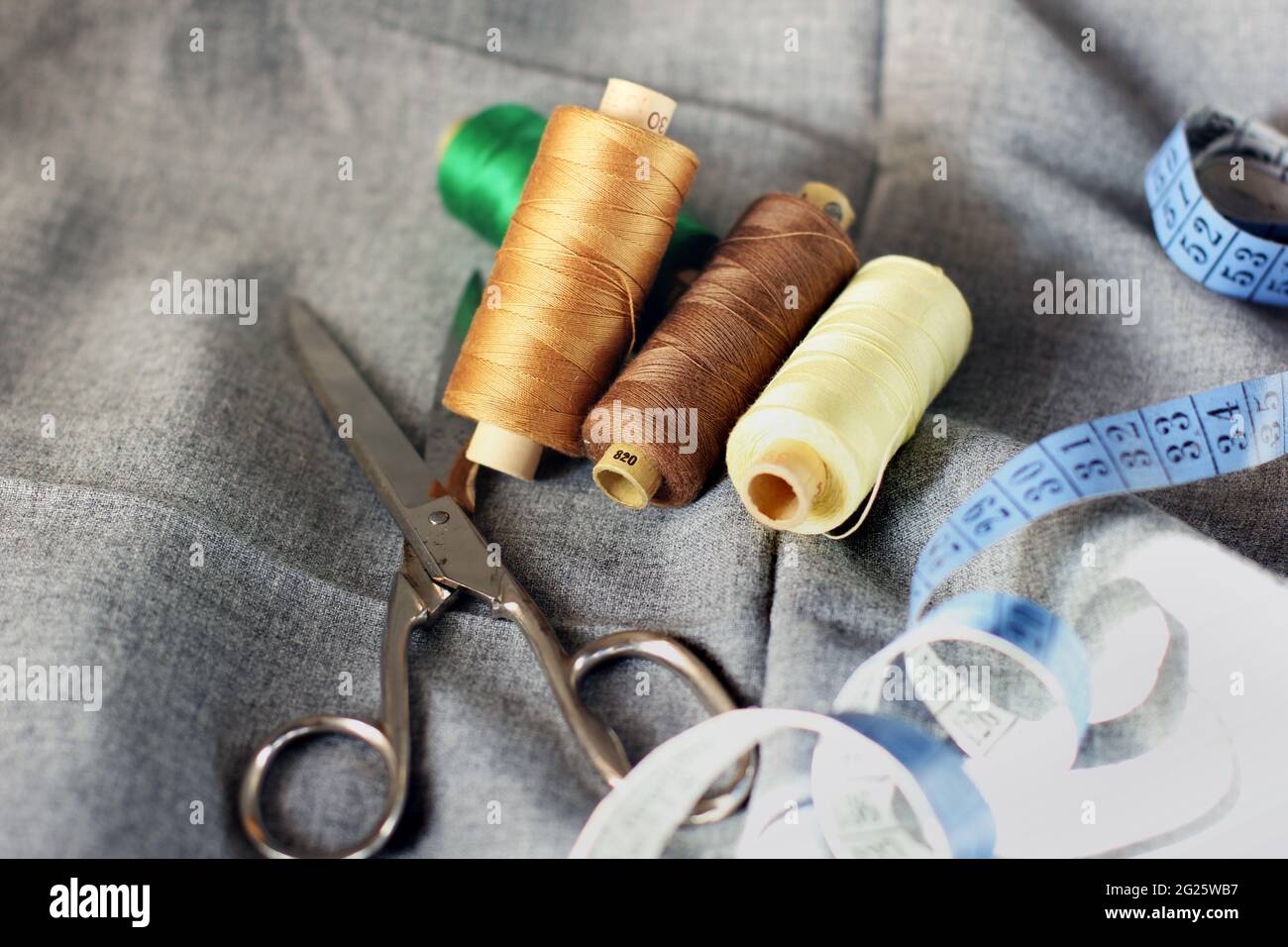 Sewing. Spools of thread on the fabric. Threads. Meter and scissors ...