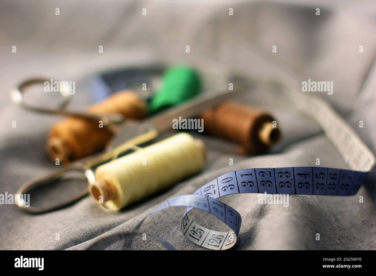 Sewing. Spools of thread on the fabric. Threads. Meter and scissors ...
