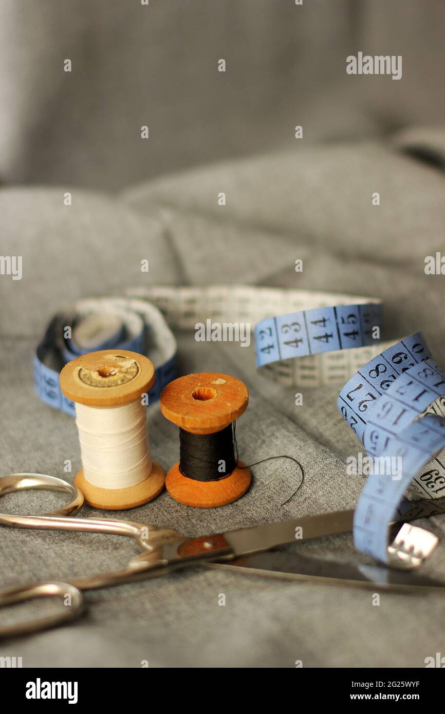 Sewing. Spools of thread on the fabric. Threads. Meter and scissors ...